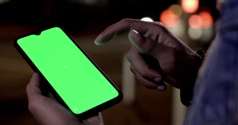Man tapping on green screen mobile phone... | Stock Video | Pond5
