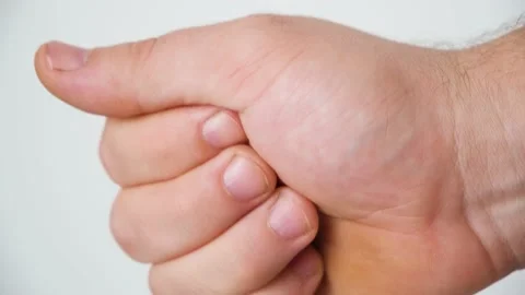 A man tenses a palm muscle on the hill o... | Stock Video | Pond5