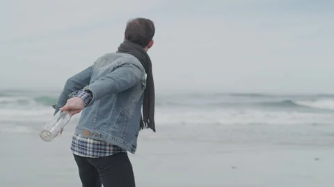 Man Throwing Message in a Bottle Into th... | Stock Video | Pond5