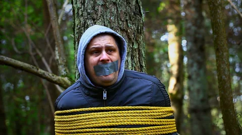Man tied to a tree in the forest episode... | Stock Video | Pond5