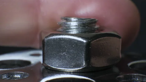 A man tightens a bolt nut close-up. Indu... | Stock Video | Pond5