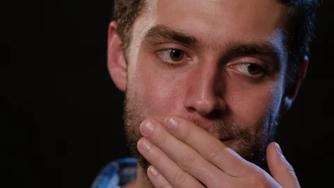 A Man Touching his Lips Against a Black ... | Stock Video | Pond5