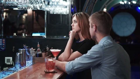man trying to pick up a woman at the bar | Stock Video | Pond5