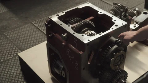 Man turns shaft with gears in disassembl... | Stock Video | Pond5