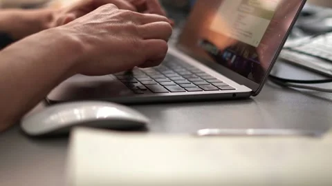 A man is typing text on a laptop keyboar... | Stock Video | Pond5