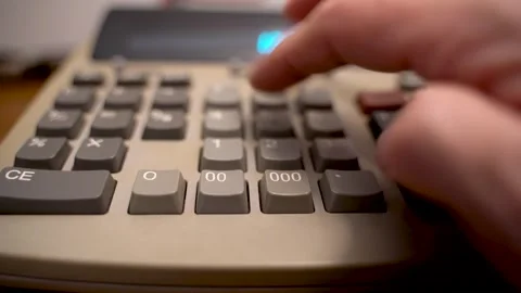 A Man Using a Calculator at Work | Stock Video | Pond5