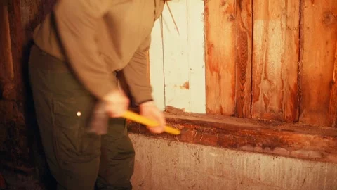 A Man is Using a Claw Bar to Pry Off the... | Stock Video | Pond5
