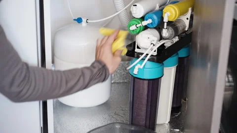 A man is using a cloth to wipe up the wa... | Stock Video | Pond5