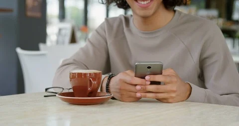 Man using mobile phone in coffee shop 4k | Stock Video | Pond5