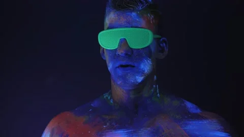 A man with UV drawings on his body stand... | Stock Video | Pond5