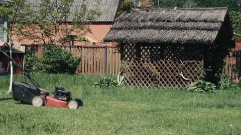 Man walk behind or push petrol lawnmower... | Stock Video | Pond5