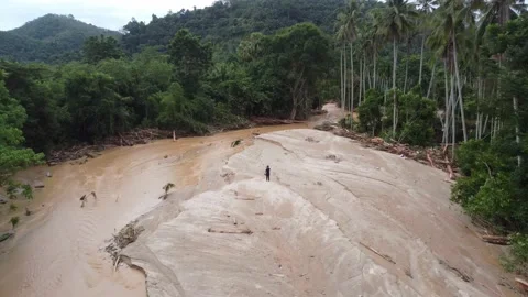 A man walk at river bank destroy by flas... | Stock Video | Pond5