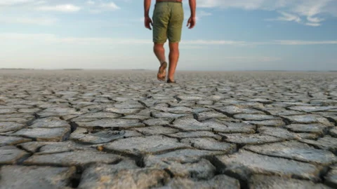 Man walking barefoot on bottom of dried ... | Stock Video | Pond5