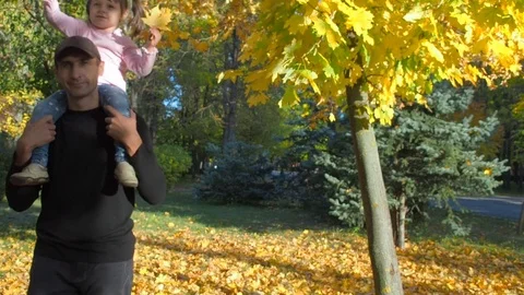 A man is walking with a child on his sho... | Stock Video | Pond5