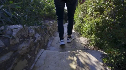 Man walking down a path of rock stairs b... | Stock Video | Pond5