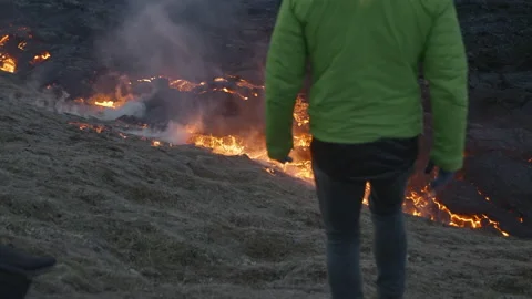 Man Walking To Lava Flow From Erupting F... | Stock Video | Pond5