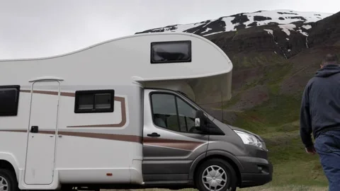 Man walking to RV and drivers side 4K in... | Stock Video | Pond5