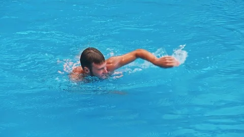Man walking in the swimming pool on sunn... | Stock Video | Pond5