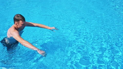 Man walking in the swimming pool on sunn... | Stock Video | Pond5