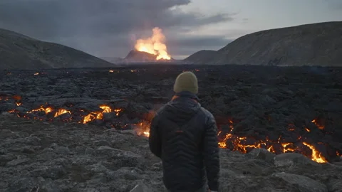 Man Walking Towards Lava Flow From Erupt... | Stock Video | Pond5