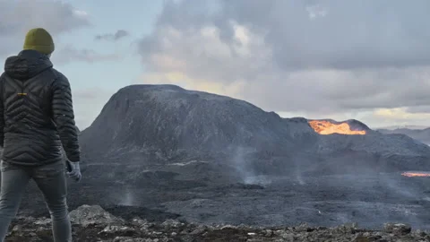 Man Walking Towards Lava Flow From Erupt... | Stock Video | Pond5