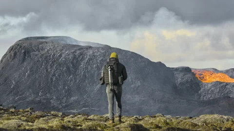 Man Walking Towards Lava Flow From Erupt... | Stock Video | Pond5