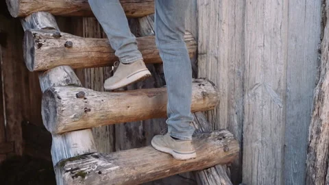 Man Walking Up Wooden Ladder To Explore ... | Stock Video | Pond5