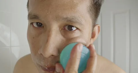 A man washes his face with soap to clean... | Stock Video | Pond5