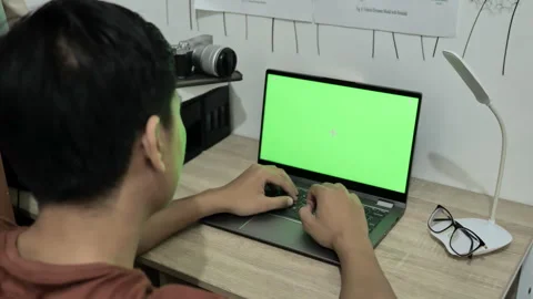 A man watching a green screen laptop on ... | Stock Video | Pond5