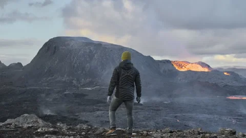 Man Watching Lava Flow From Erupting Fag... | Stock Video | Pond5