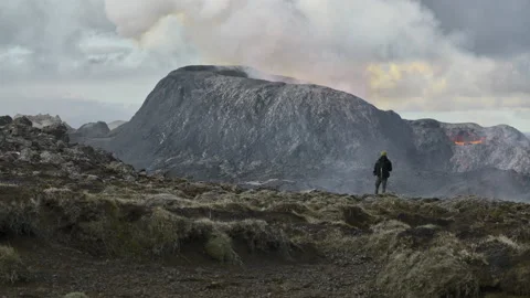 Man Watching Lava Flow From Erupting Fag... | Stock Video | Pond5