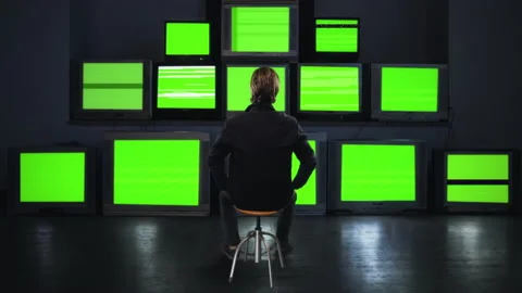 Man Watching Multiscreen Monitors Green ... | Stock Video | Pond5