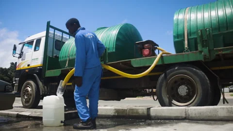 Man with water truck filling containers ... | Stock Video | Pond5