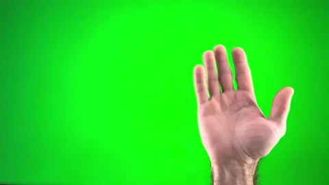 a man waves his hand on a green backgrou... | Stock Video | Pond5