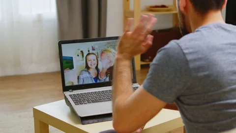 Man waving on video call with his family | Stock Video | Pond5