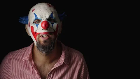 A man wearing a scary evil clown mask in... | Stock Video | Pond5
