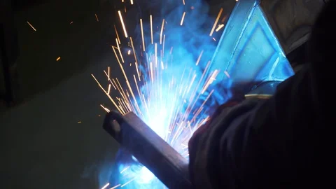 Man welds metal structure, blue flames a... | Stock Video | Pond5