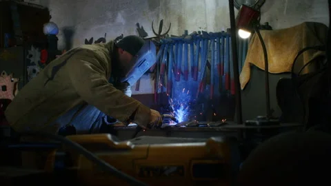 A man welds plates for body armor from s... | Stock Video | Pond5