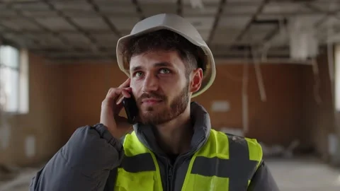 A man in a white safety helmet at a cons... | Stock Video | Pond5