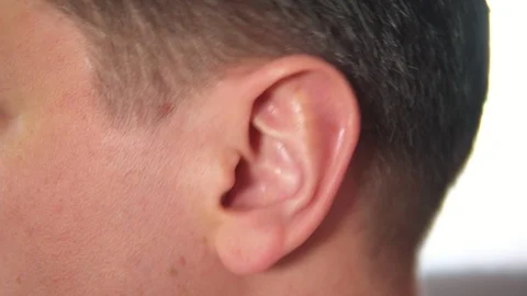 Man wiggles his ear. Ear in profile | Stock Video | Pond5