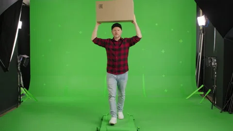 Man worker holding a box walking on Gree... | Stock Video | Pond5