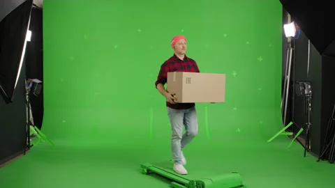 Man worker holding a box walking on Gree... | Stock Video | Pond5
