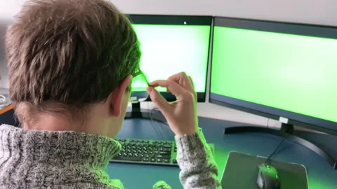 man works in office at two computers gre... | Stock Video | Pond5