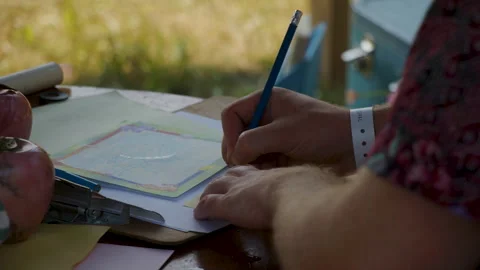 Man writing at letter writing station at... | Stock Video | Pond5