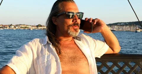 Man on yacht deck talking on the phone a... | Stock Video | Pond5