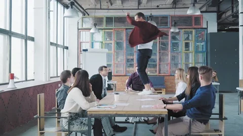 Managers have fun dancing on the table i... | Stock Video | Pond5