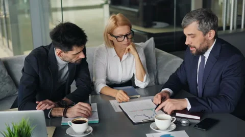 Managers working in cafe looking at char... | Stock Video | Pond5
