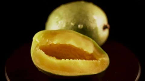 Mango fruit rotating on black background... | Stock Video | Pond5