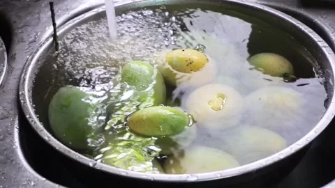 Mangoes fruit washing in sink | Stock Video | Pond5