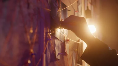 A Man's Backlit Hand Pinning Evidence to... | Stock Video | Pond5